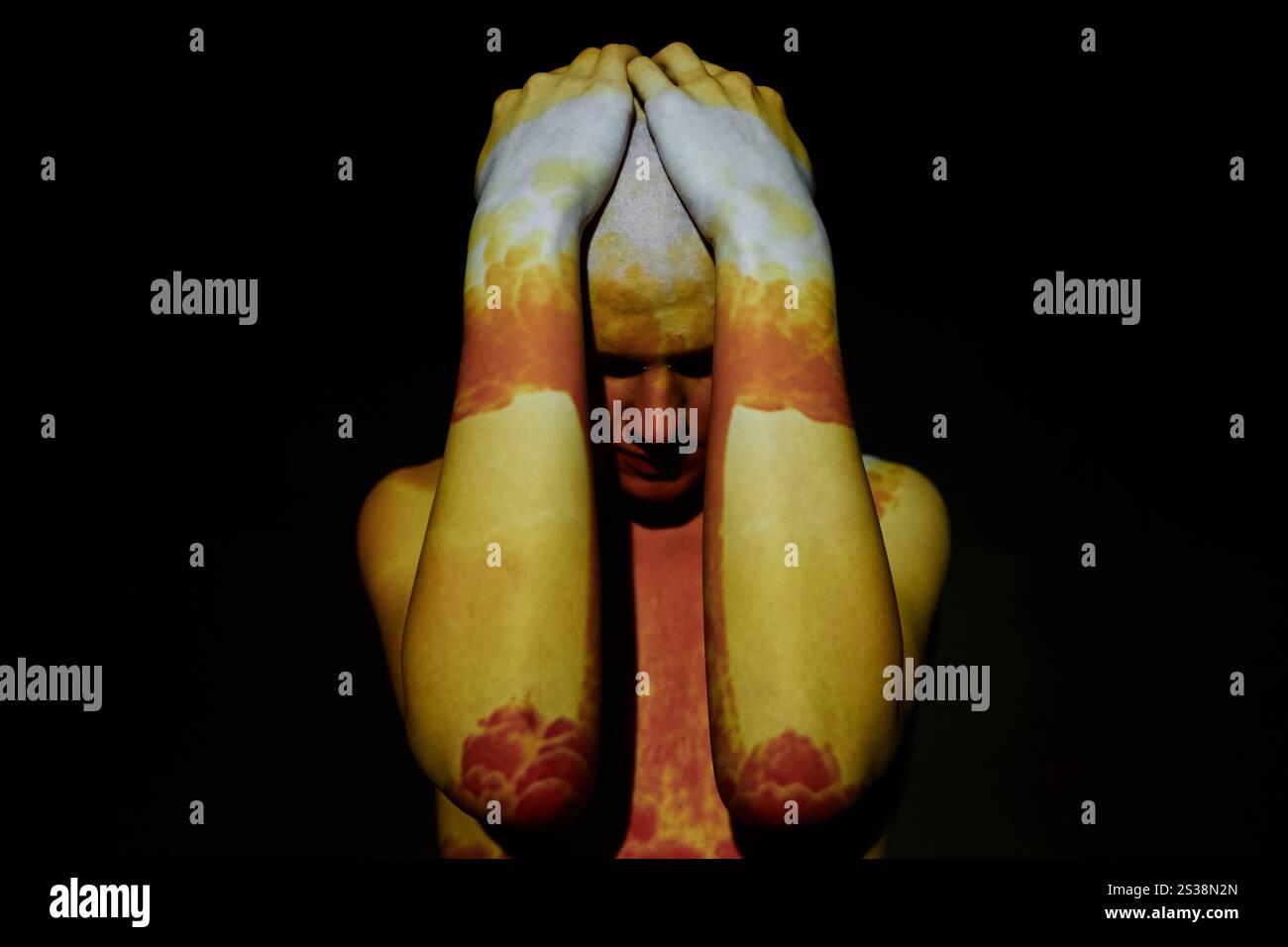 Medium shot of terrified bald man covering head with hands hiding from ...