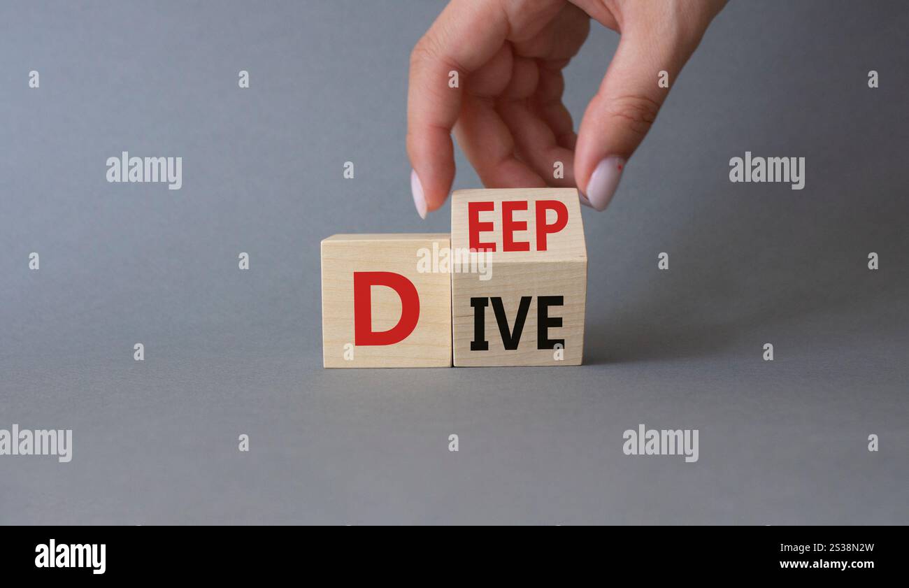 Deep Dive symbol. Businessman hand. Concept words deep dive on wooden cubes. Beautiful grey ...