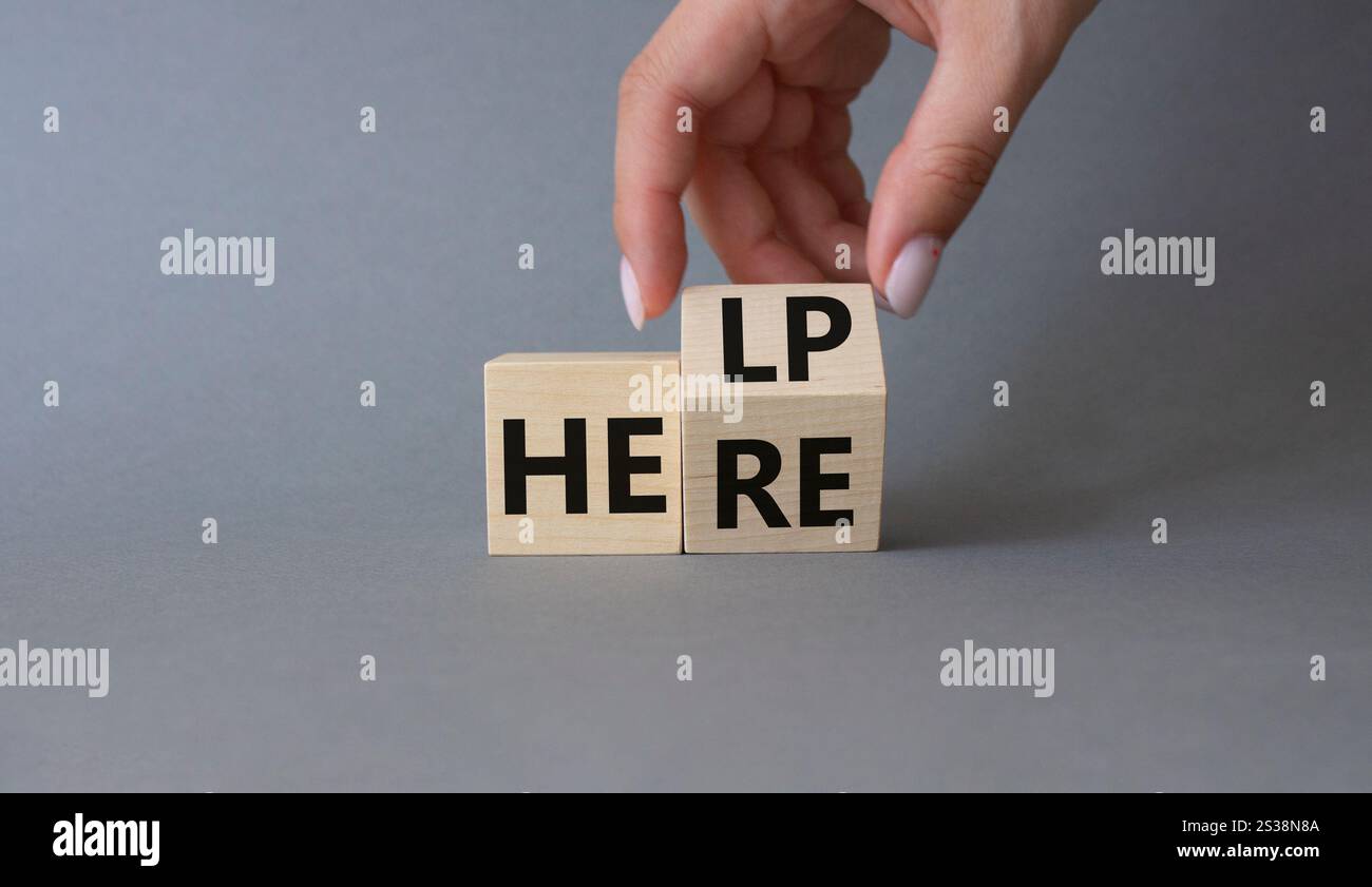 Help is here symbol. Businessman hand Turnes cube and changes word Here ...