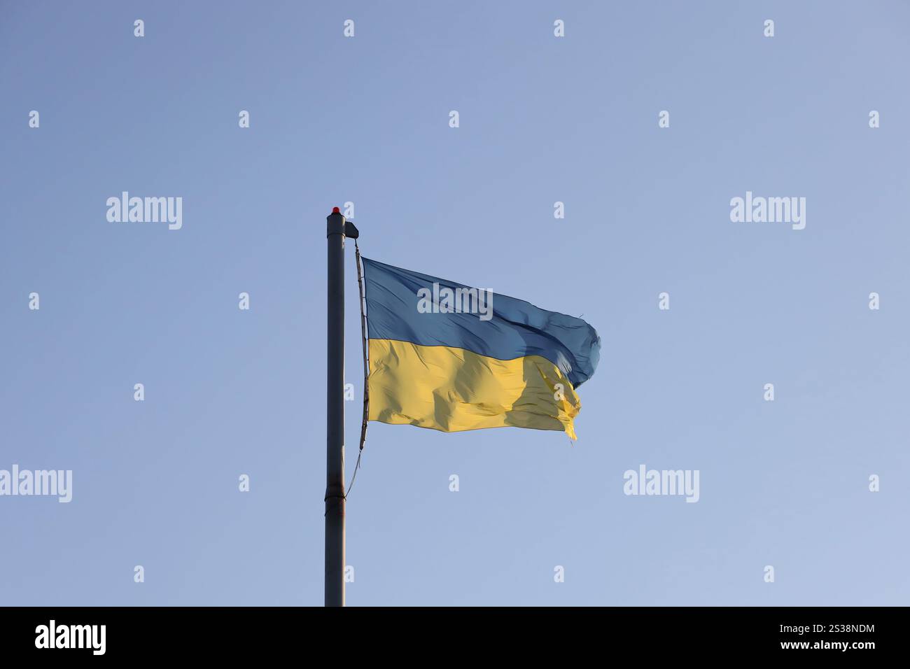 Ukraine flag large national symbol fluttering in blue sky. Large yellow ...