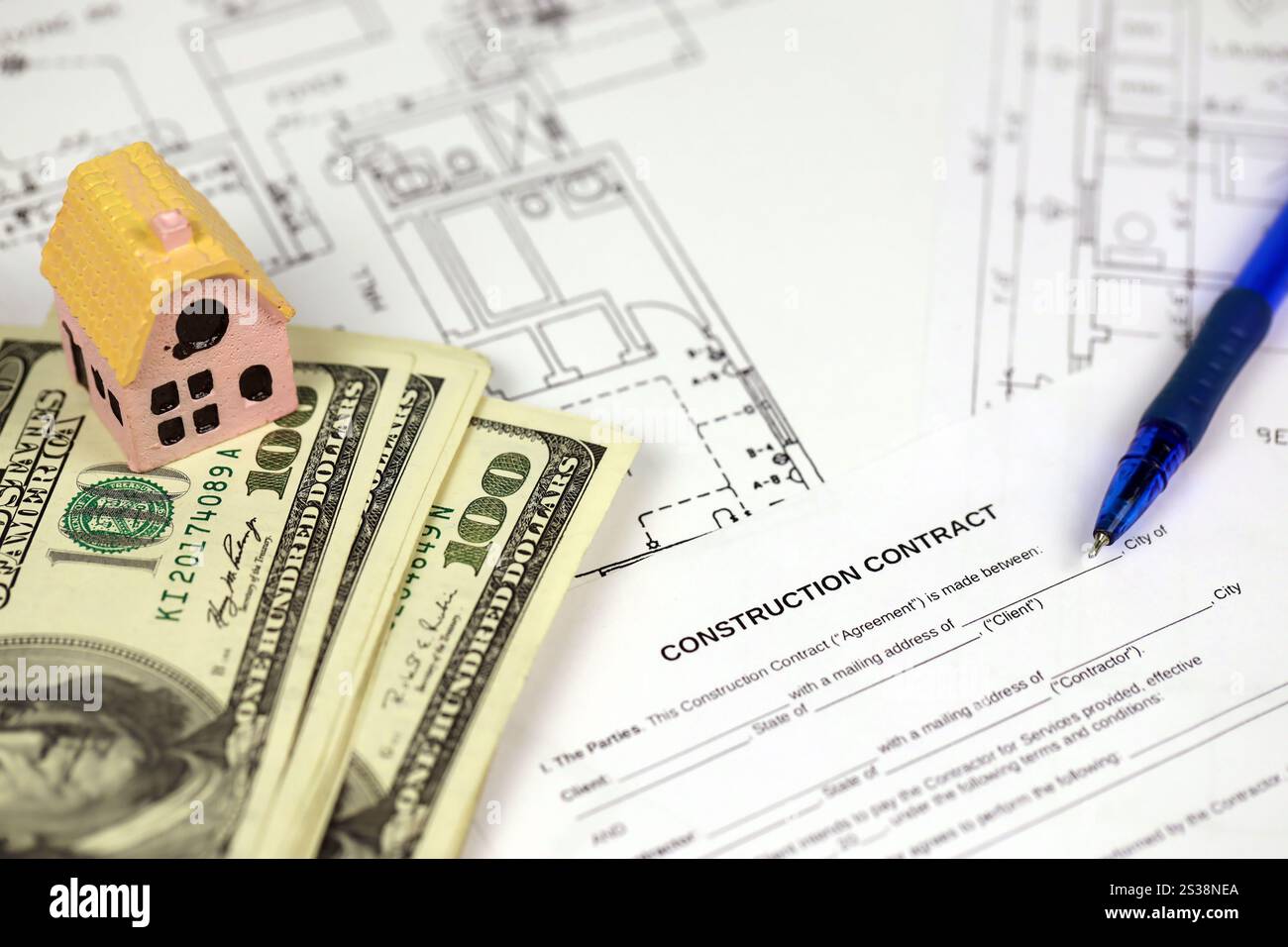 Residential construction agreement ready to sign with small toy houses ...