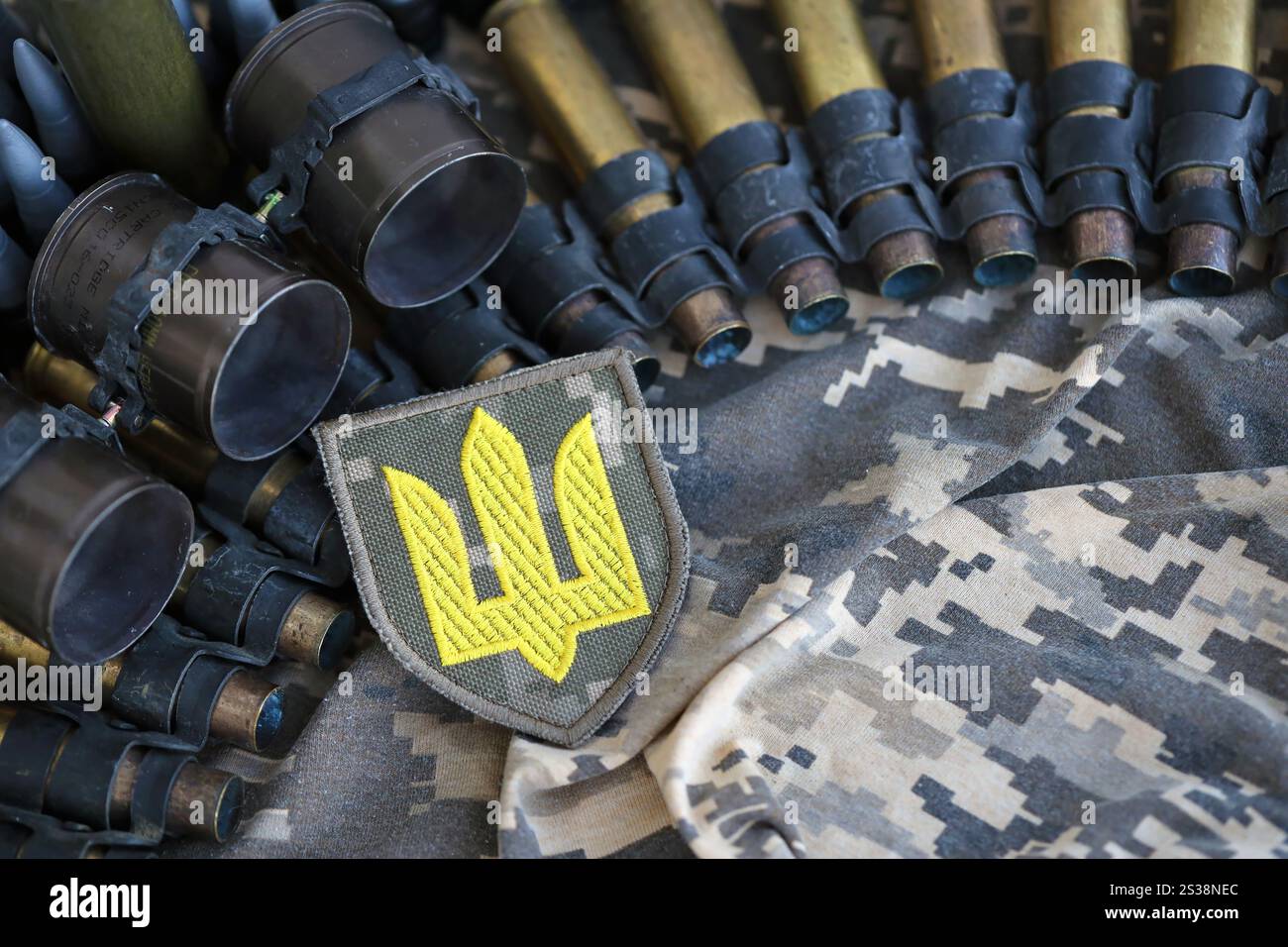 Ukrainian army symbol on machine gun belt lies on ukrainian pixeled ...