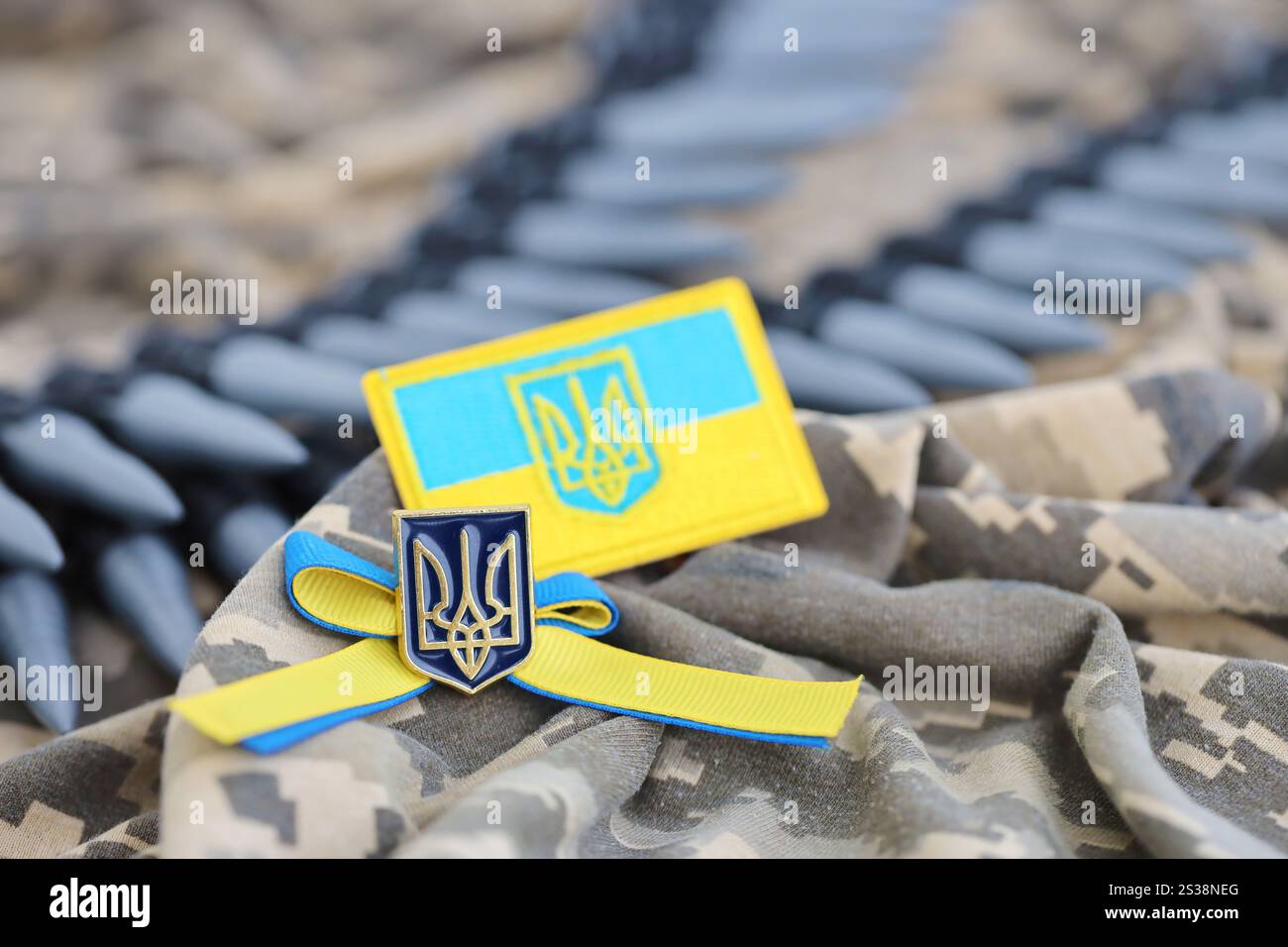Ukrainian symbol and a machine gun belt on the camouflage uniform of a ...