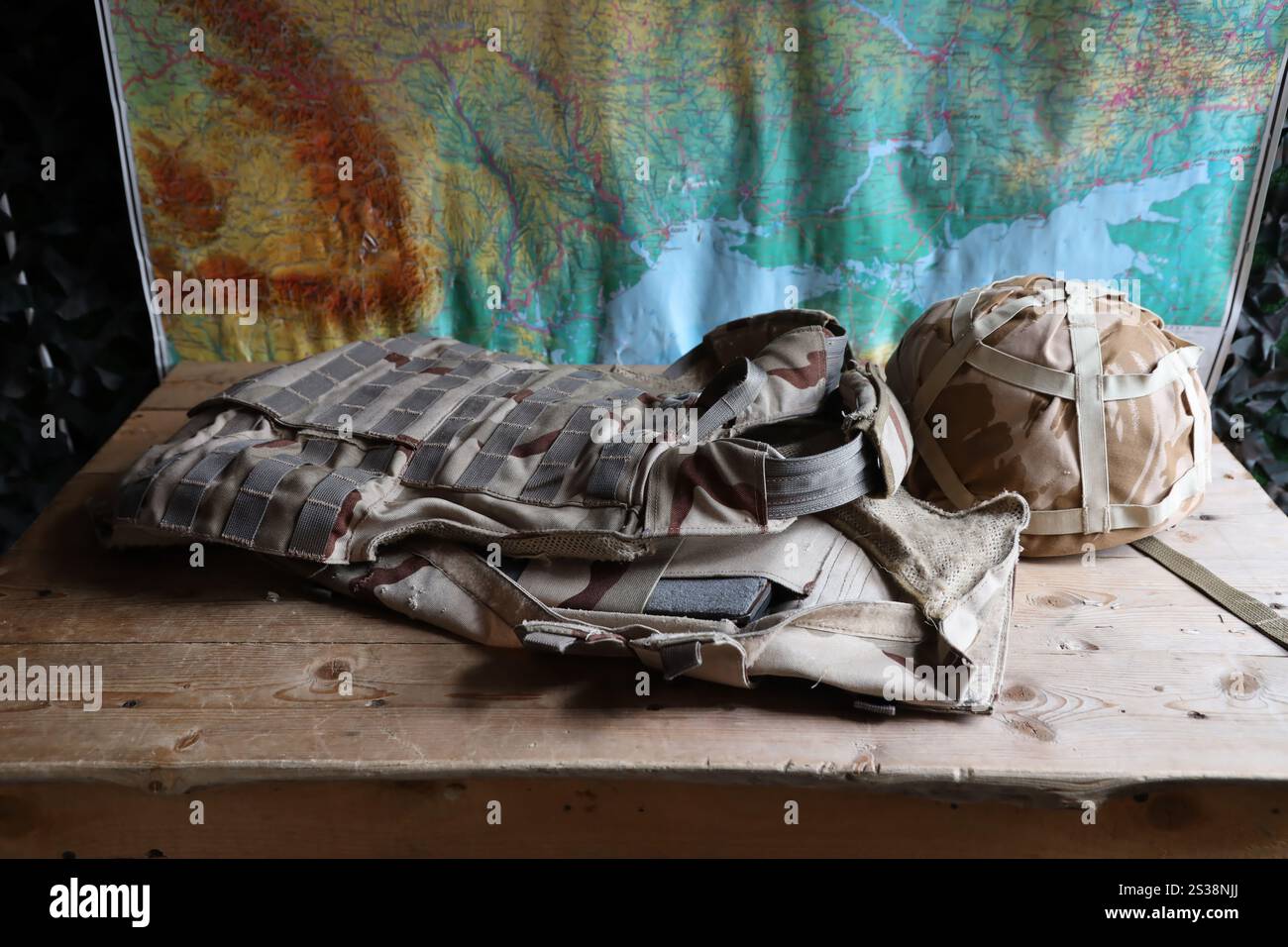 A military helmet of a Ukrainian soldier with a heavy bulletproof vest ...