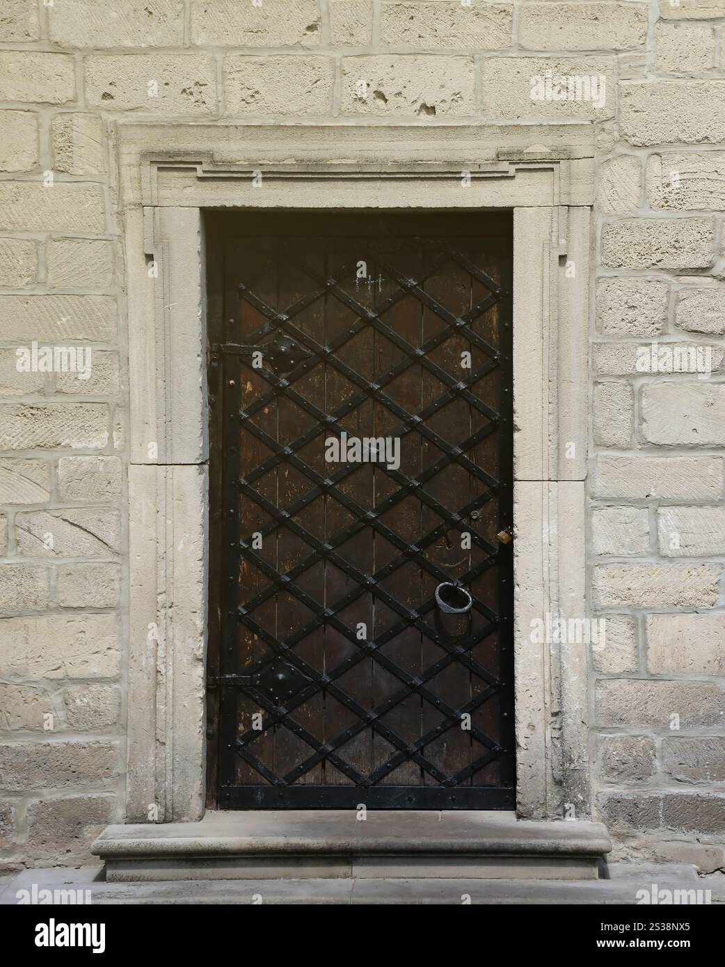 Very old solid door in brick stone wall of castle or fortress of 18th ...