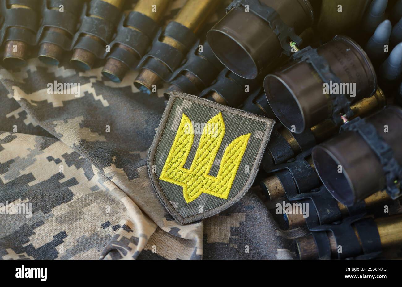 Ukrainian army symbol on machine gun belt lies on ukrainian pixeled ...