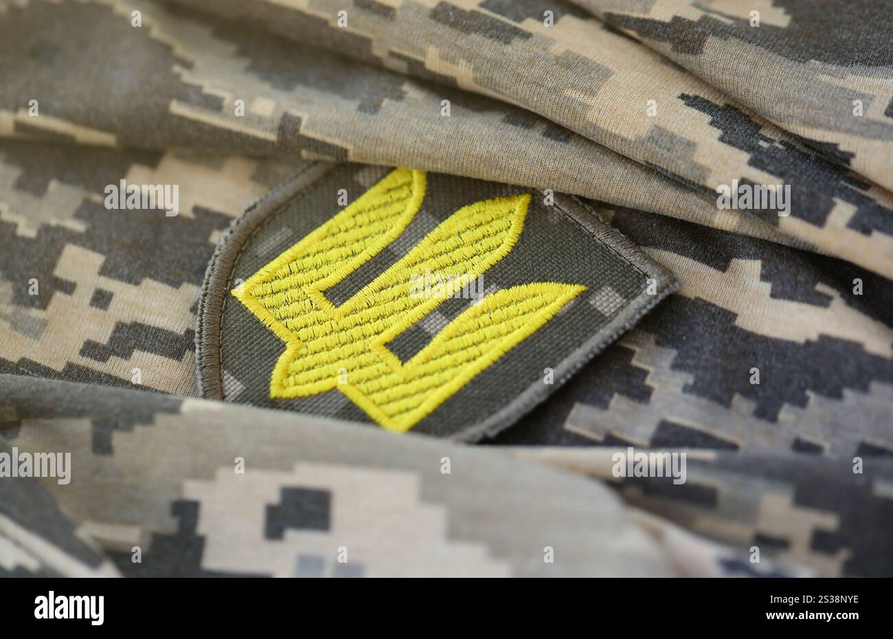 Symbol of Ukrainian army on the camouflage uniform of a Ukrainian ...