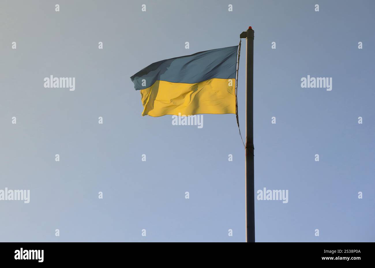 Ukraine flag large national symbol fluttering in blue sky. Large yellow ...