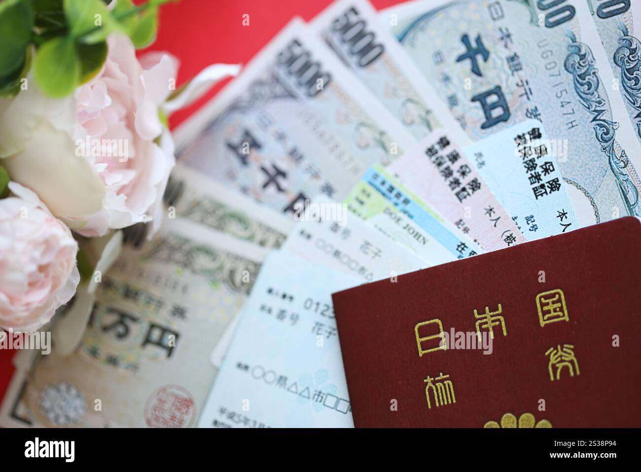 Light blue and red Japan Health Insurance cards on table with japanese ...