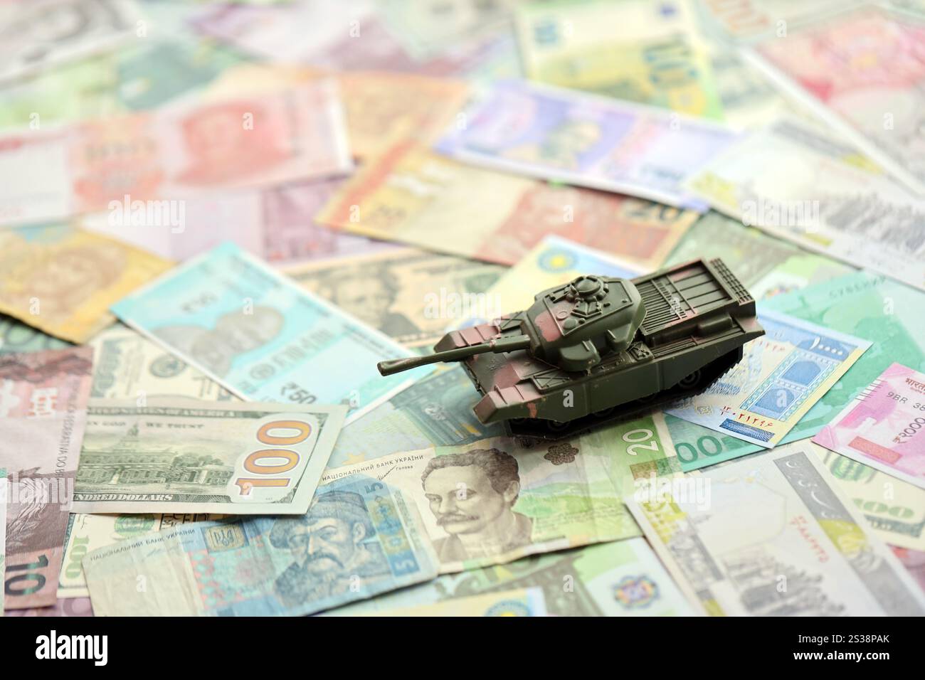 Small green tank on many banknotes of different currency. Background of ...