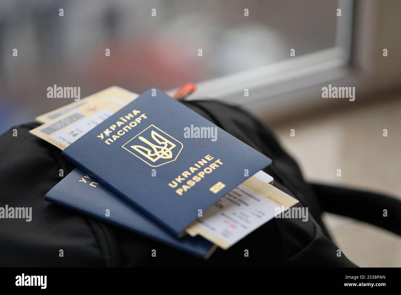 Two ukrainian biometrical passports with air flight tickets on black ...