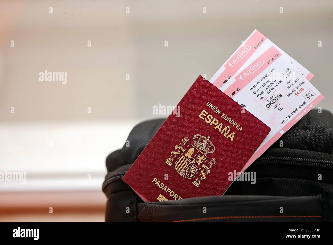 Red Spanish passport of European Union with airline tickets on ...
