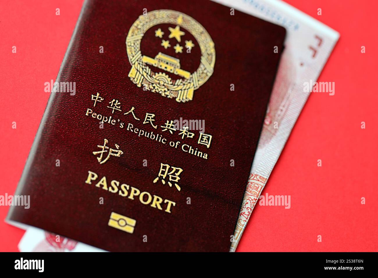 Red passport of People Republic of China and chinese yuan money bills ...