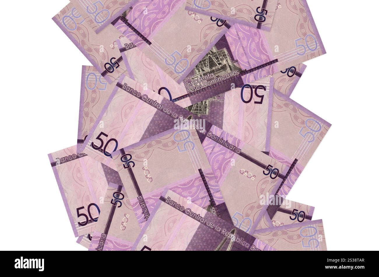 50 Dominican pesos bills flying down isolated on white. Many banknotes ...