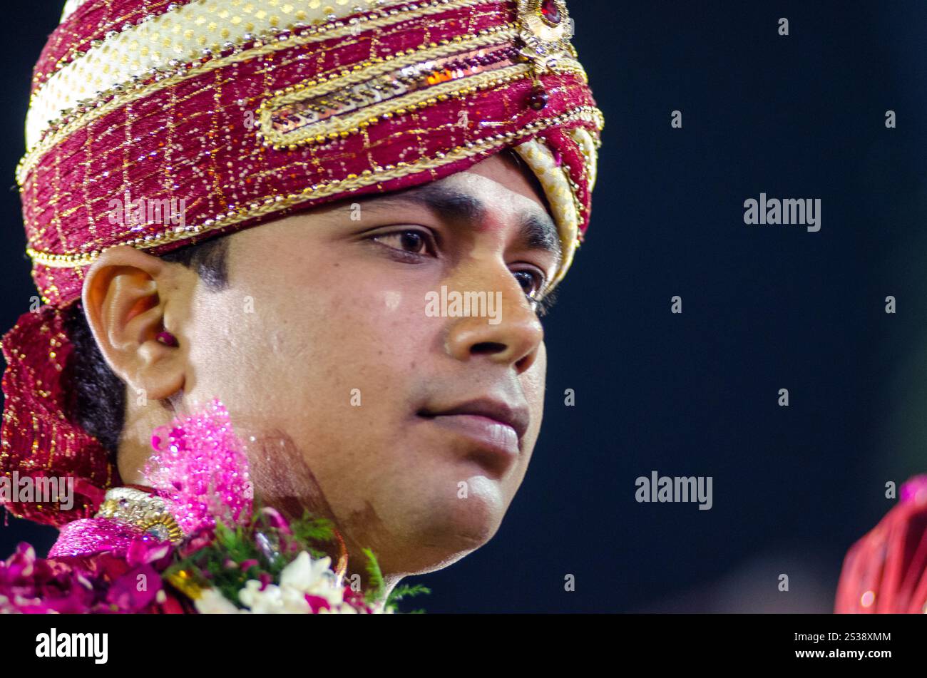 Women dressed in vibrant traditional Indian garments smile and engage ...