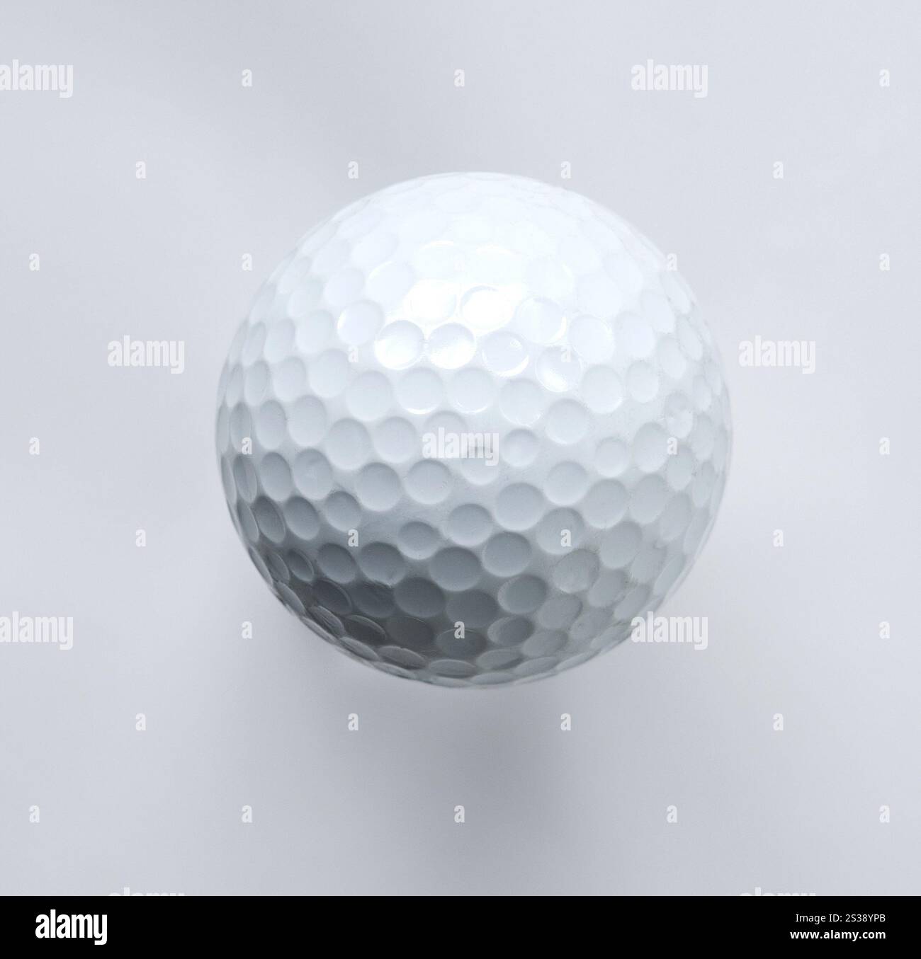 Isolated shot of a dimpled golf ball showing detail and texture against ...