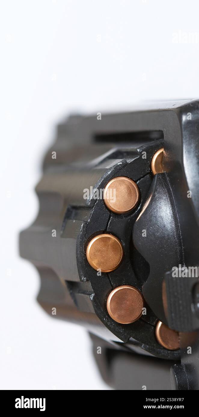 Detailed view of a loaded revolver gun cylinder on a white background ...