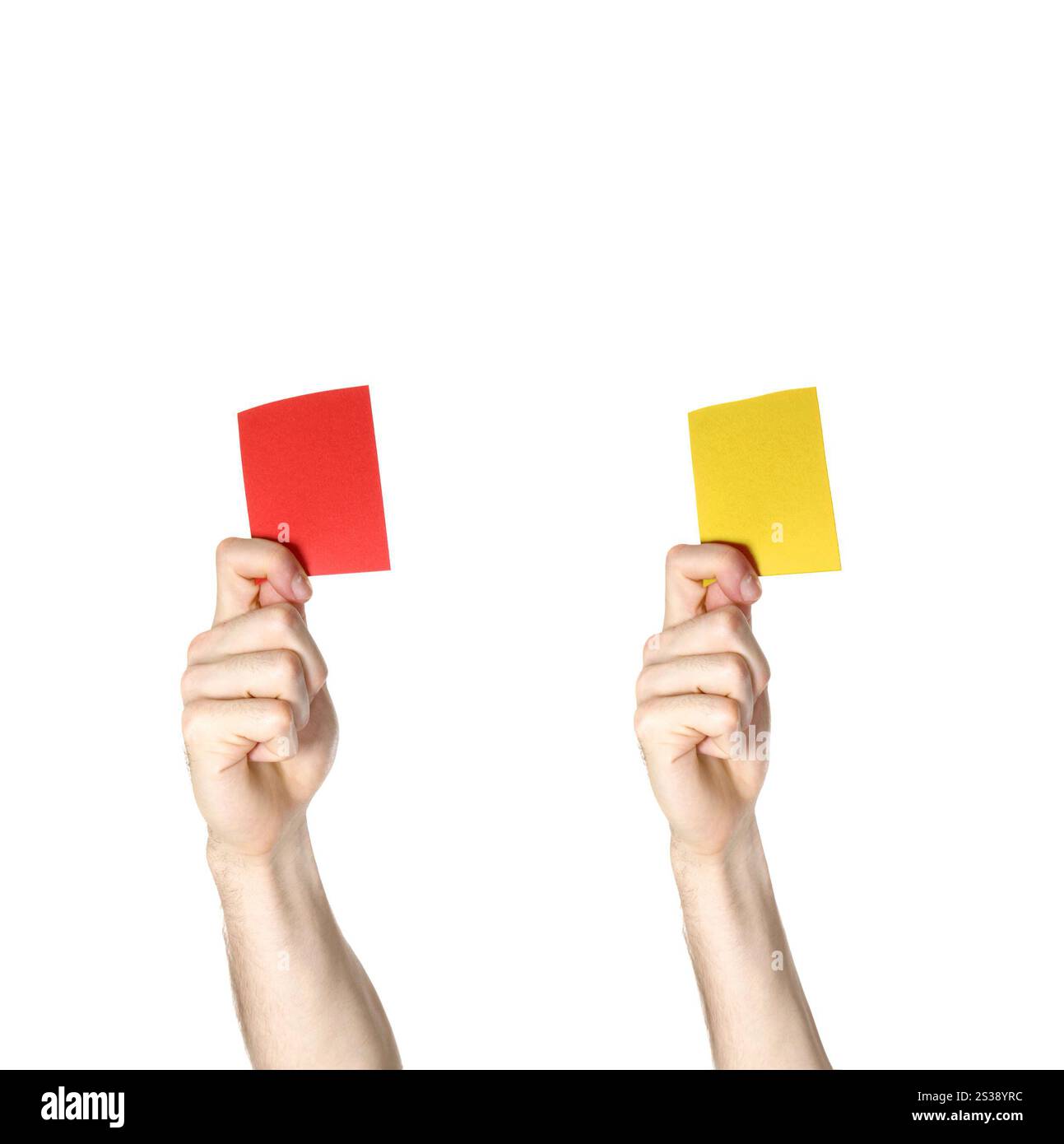 Human hands raised showing a red card and a yellow card, cut out ...