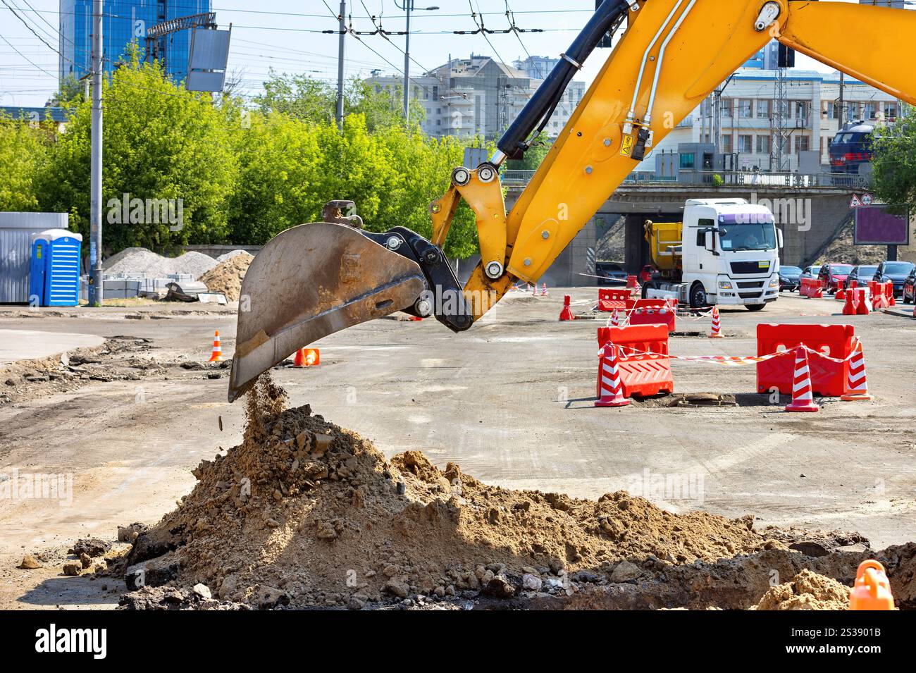 Heavy machinery at work transforming an urban construction site into a ...