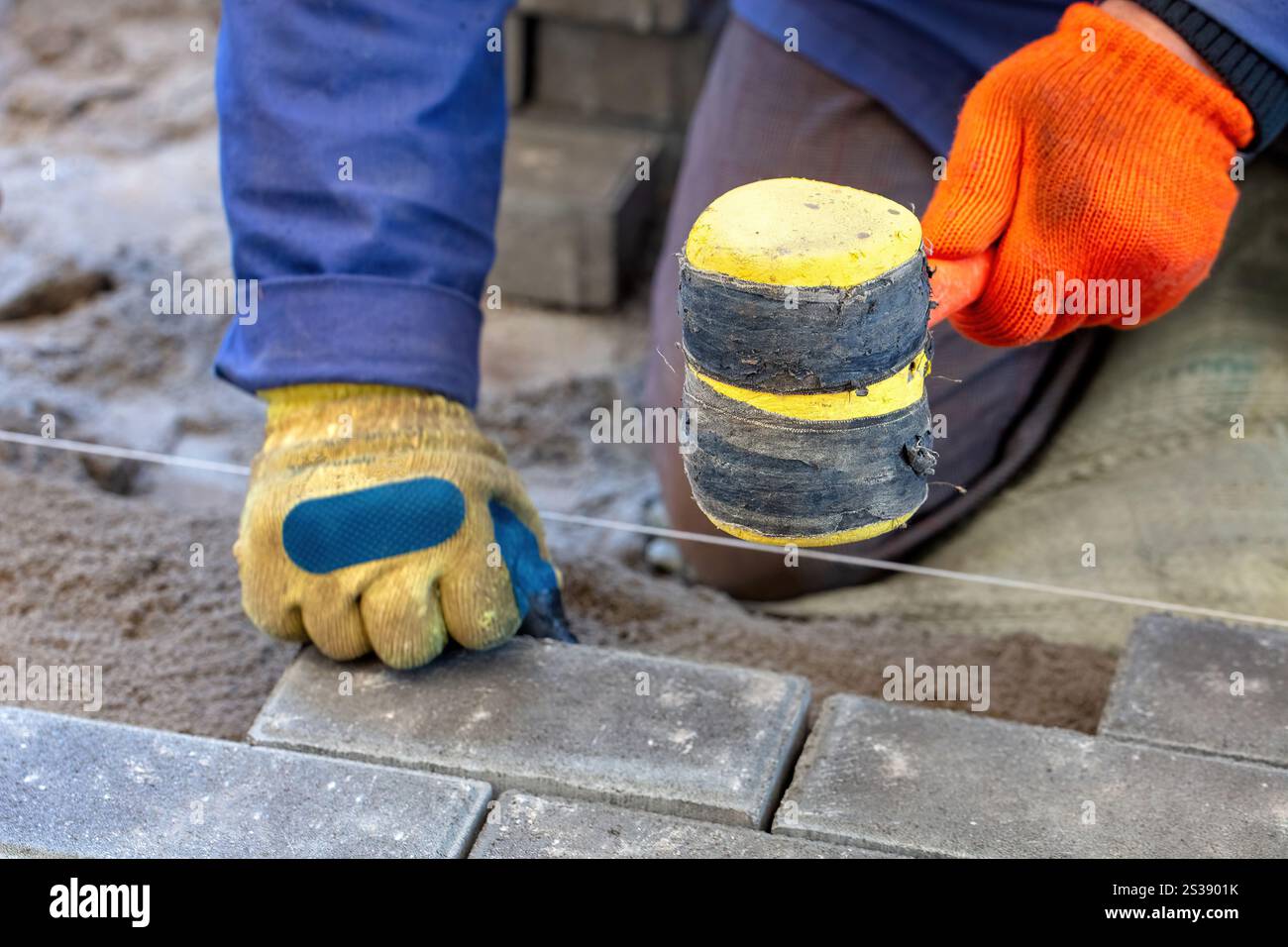 A skilled worker carefully lays bricks in a neat formation, using a ...