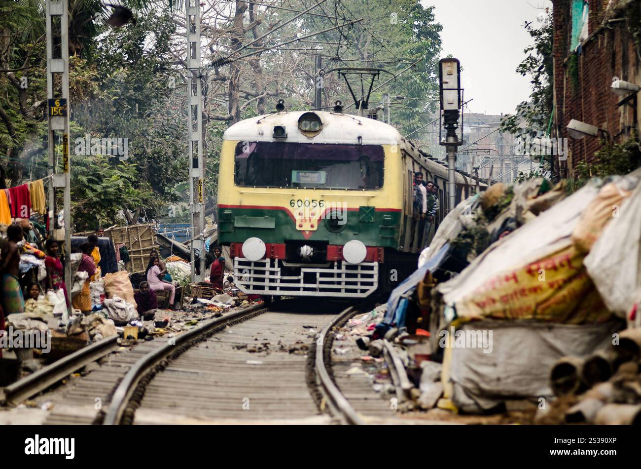 Train travels through urban landscape along railway tracks surrounded ...
