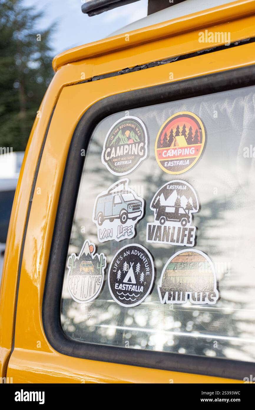 Van stickers collection on the rear window of a yellow van Stock Photo ...