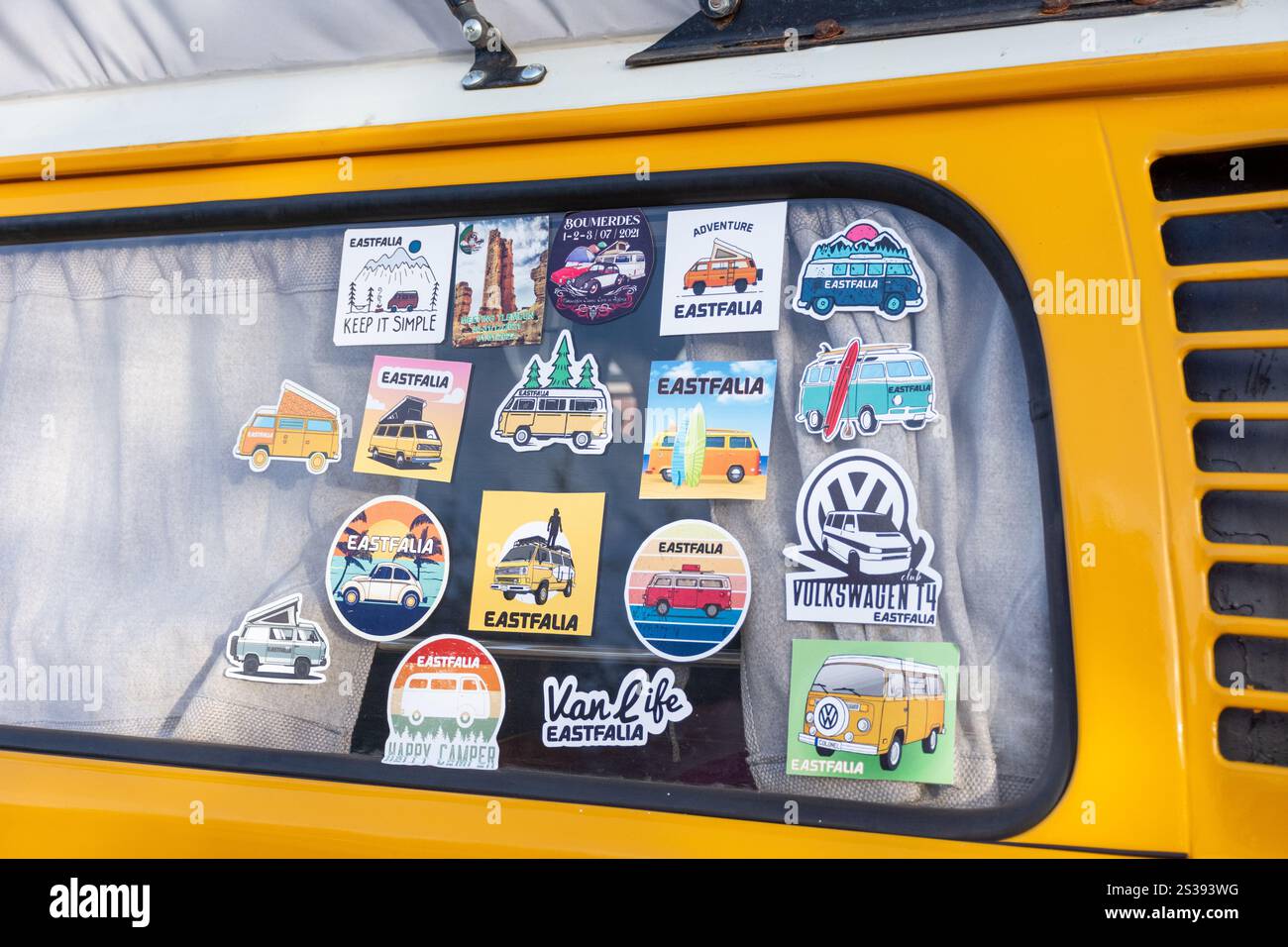 Van stickers collection on the rear window of a yellow van Stock Photo ...