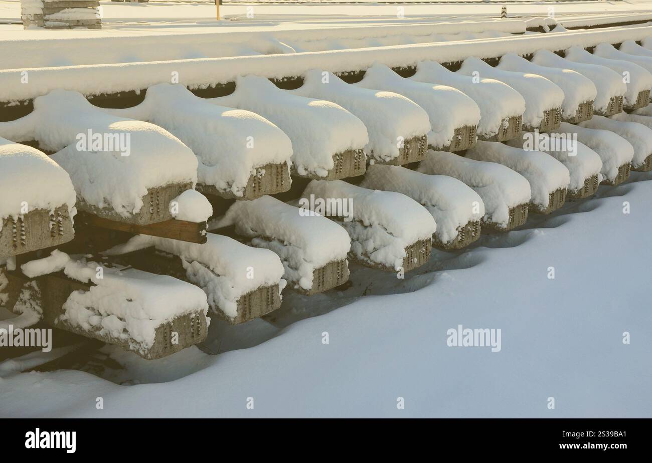 A lot of old rails and sleepers are stacked in a railway warehouse in ...