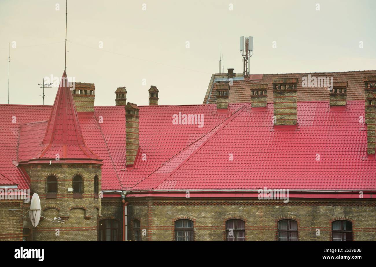 Fragment of a metal roof of the restored old multi-storey building in ...