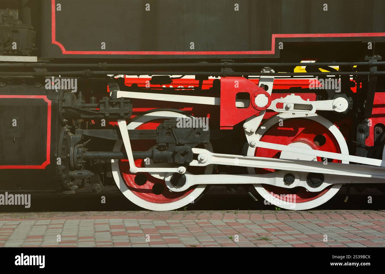 Wheels of the old black steam locomotive of Soviet times. The side of ...