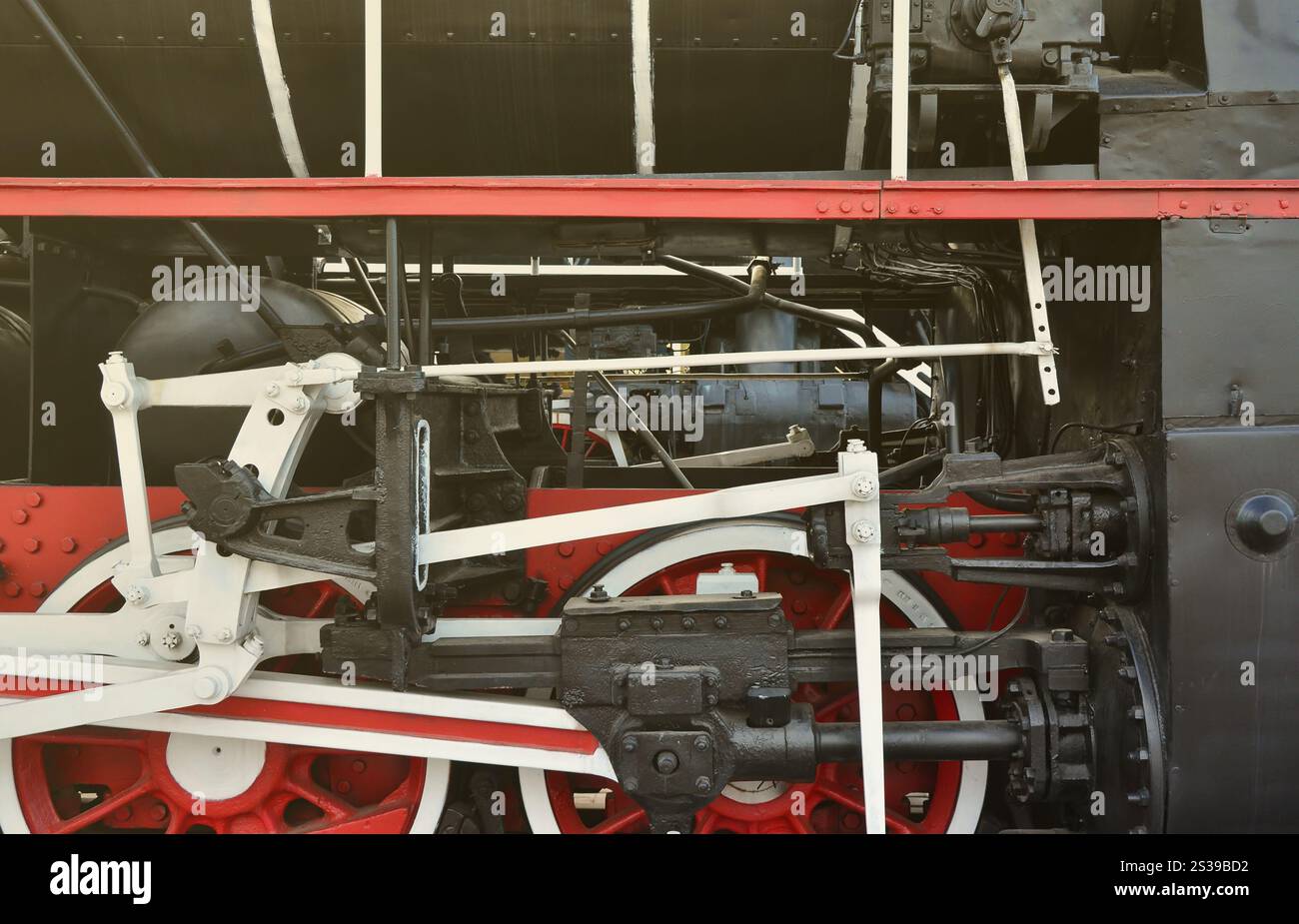 Wheels of the old black steam locomotive of Soviet times. The side of ...