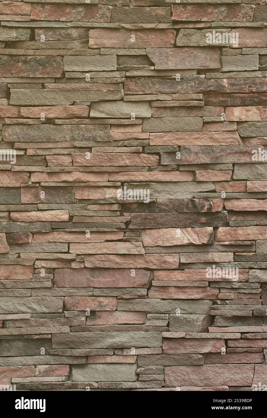 Texture of a stone wall from long and rough stones of different sizes ...
