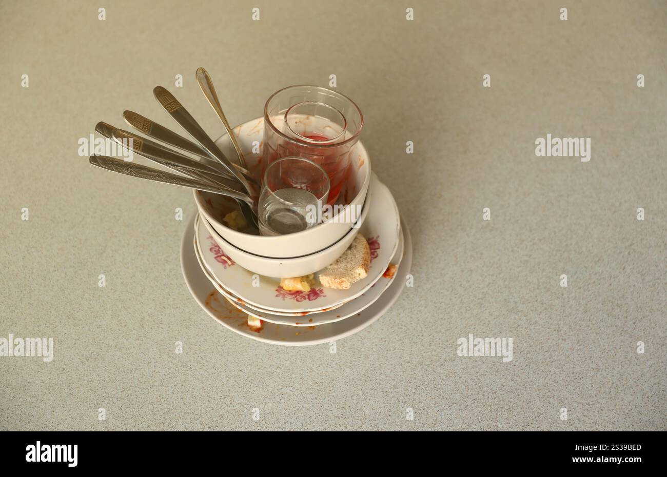 Stack of dirty dishes with food leftovers on the table after meal ...