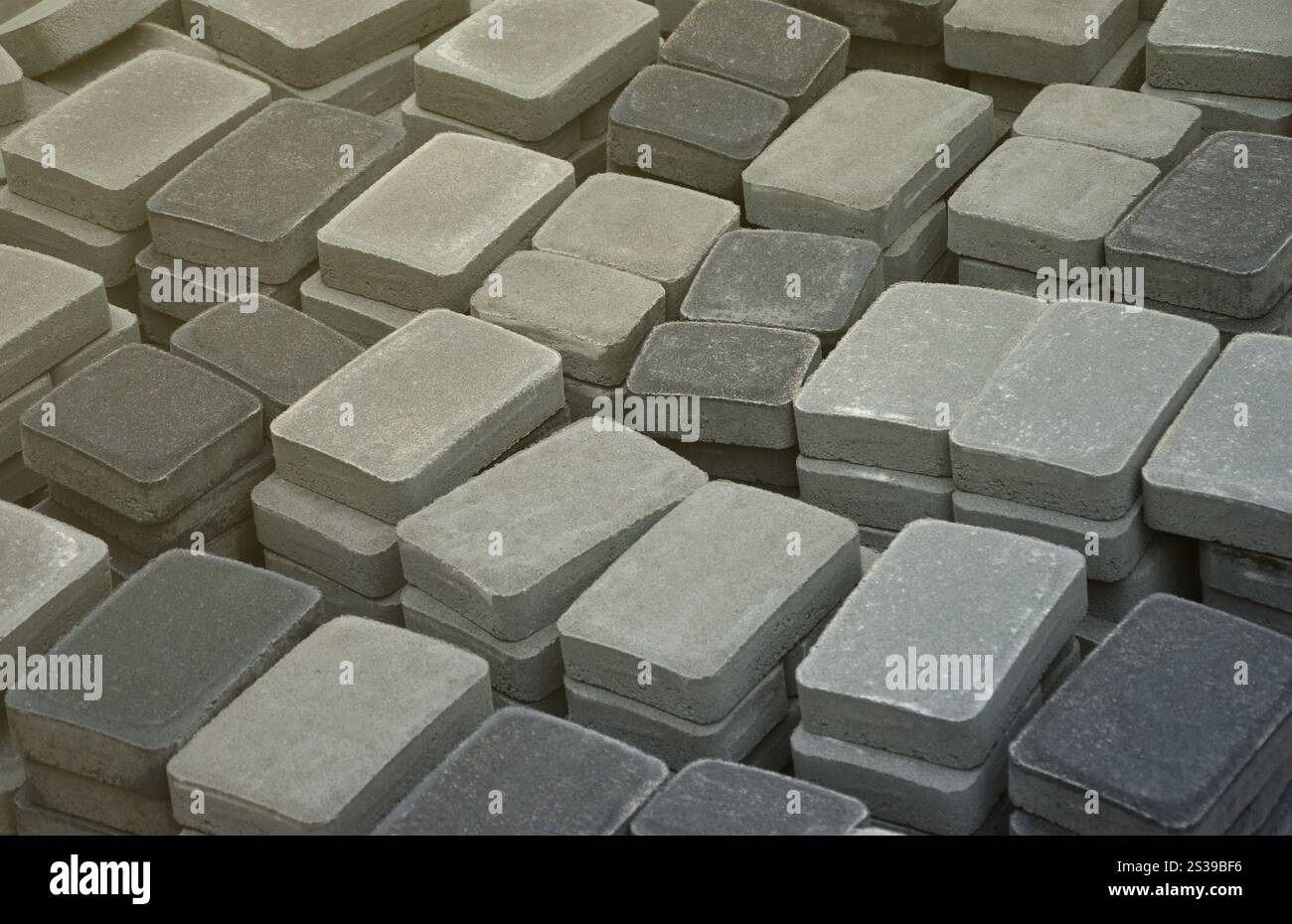 Pile of gray and dark grey walkway slab lying down outdoor. Material ...