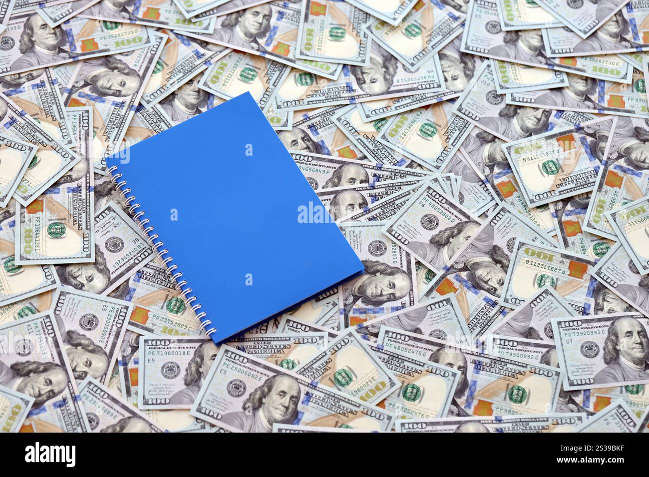 Office workplace table with blank notebook or notepad and many hundred ...