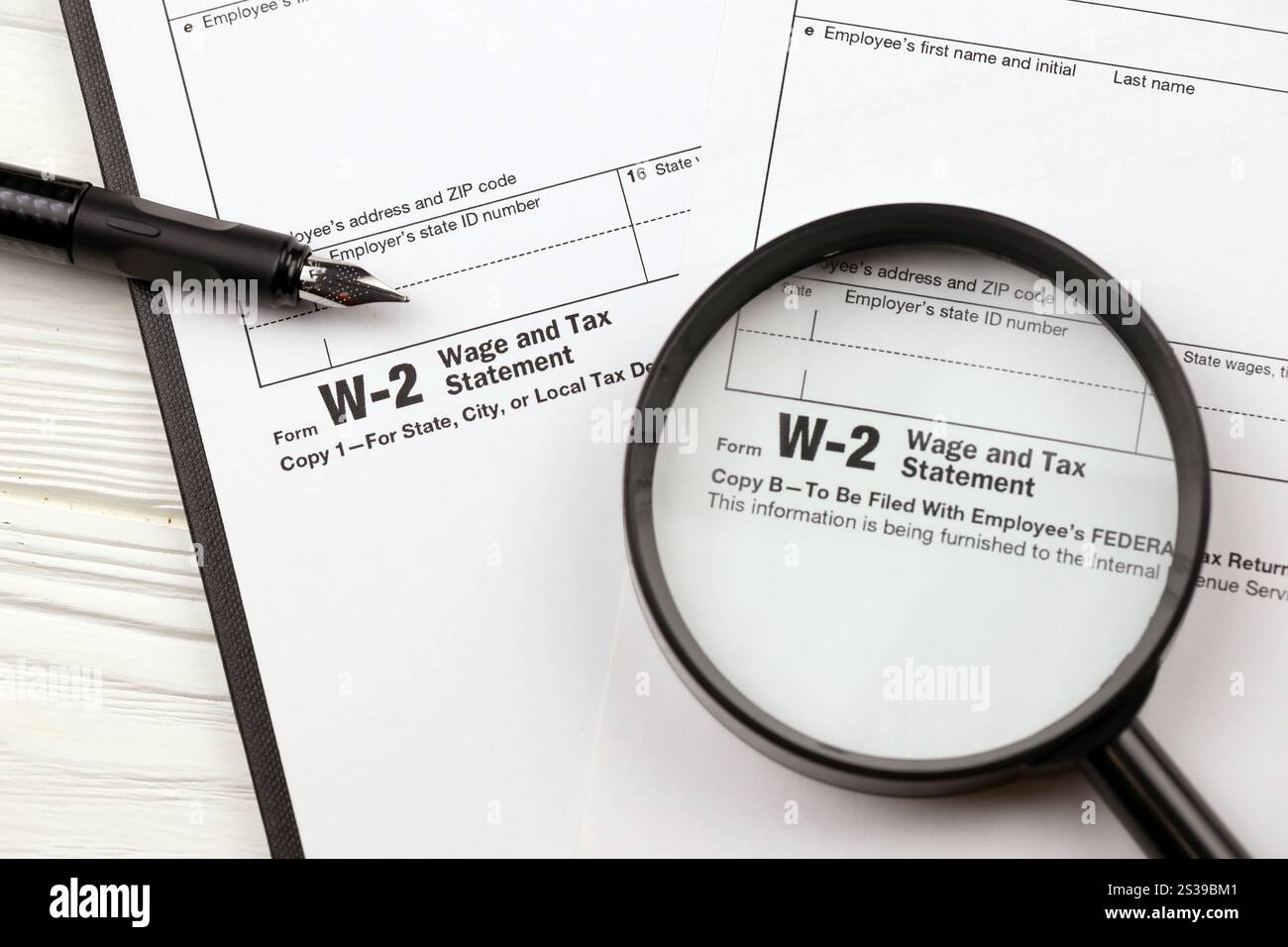 IRS Form W-2 Wage and Tax Statement blank on A4 tablet lies on office ...