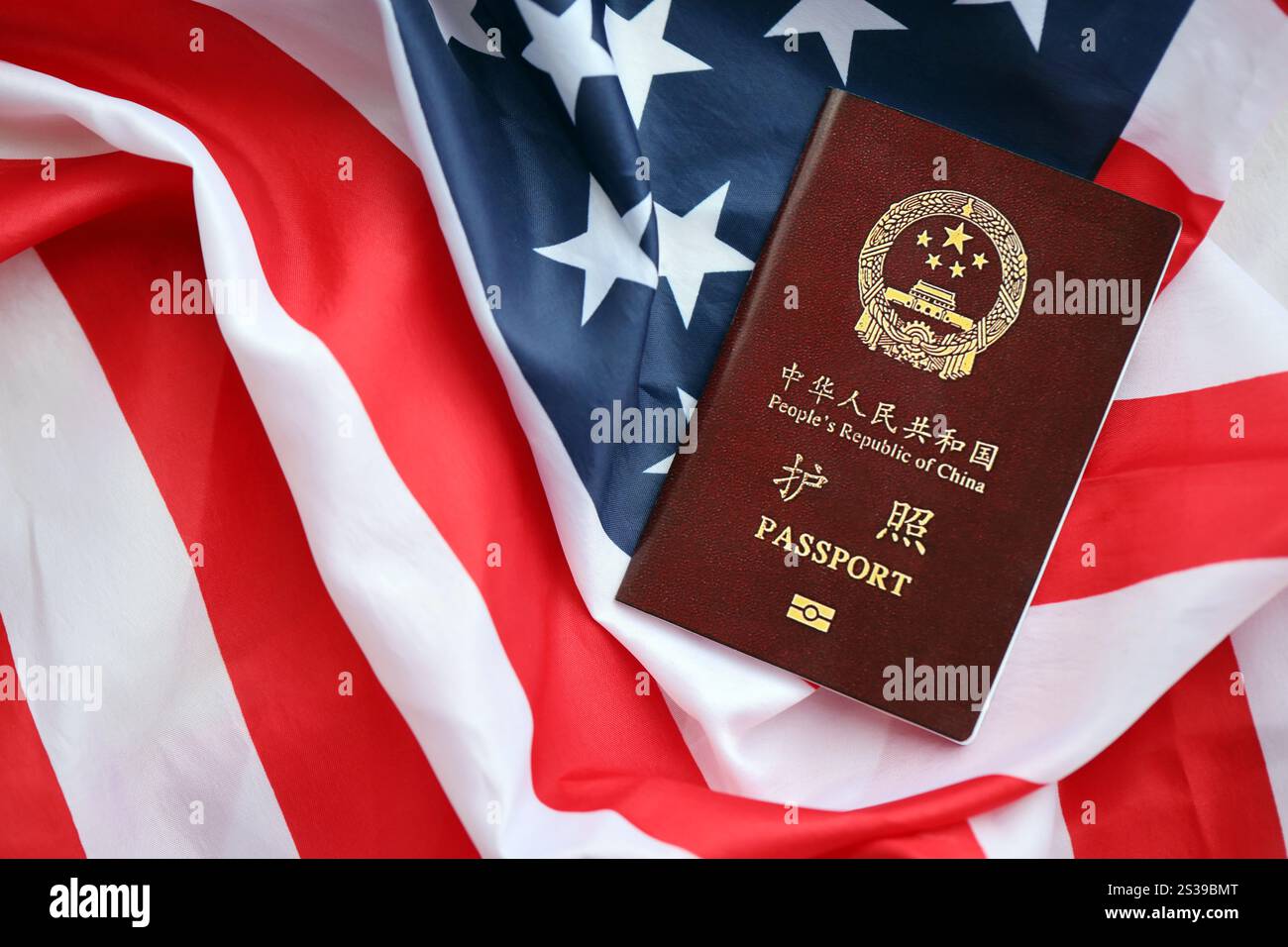 Red passport of People Republic of China on United States flag. PRC ...