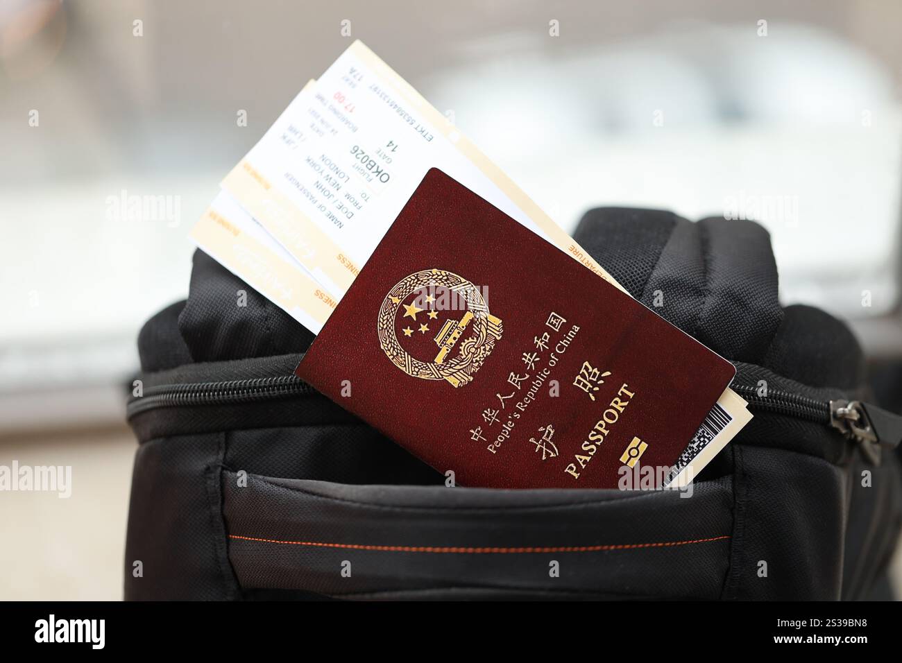 Red passport of People Republic of China with airline tickets on ...
