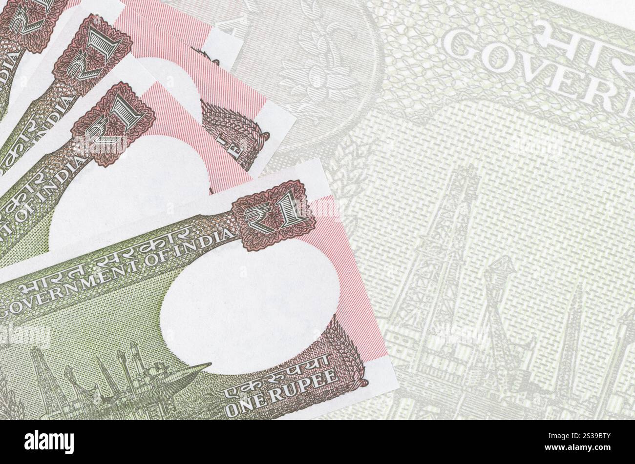 1 Indian rupee bills lies in stack on background of big semi ...