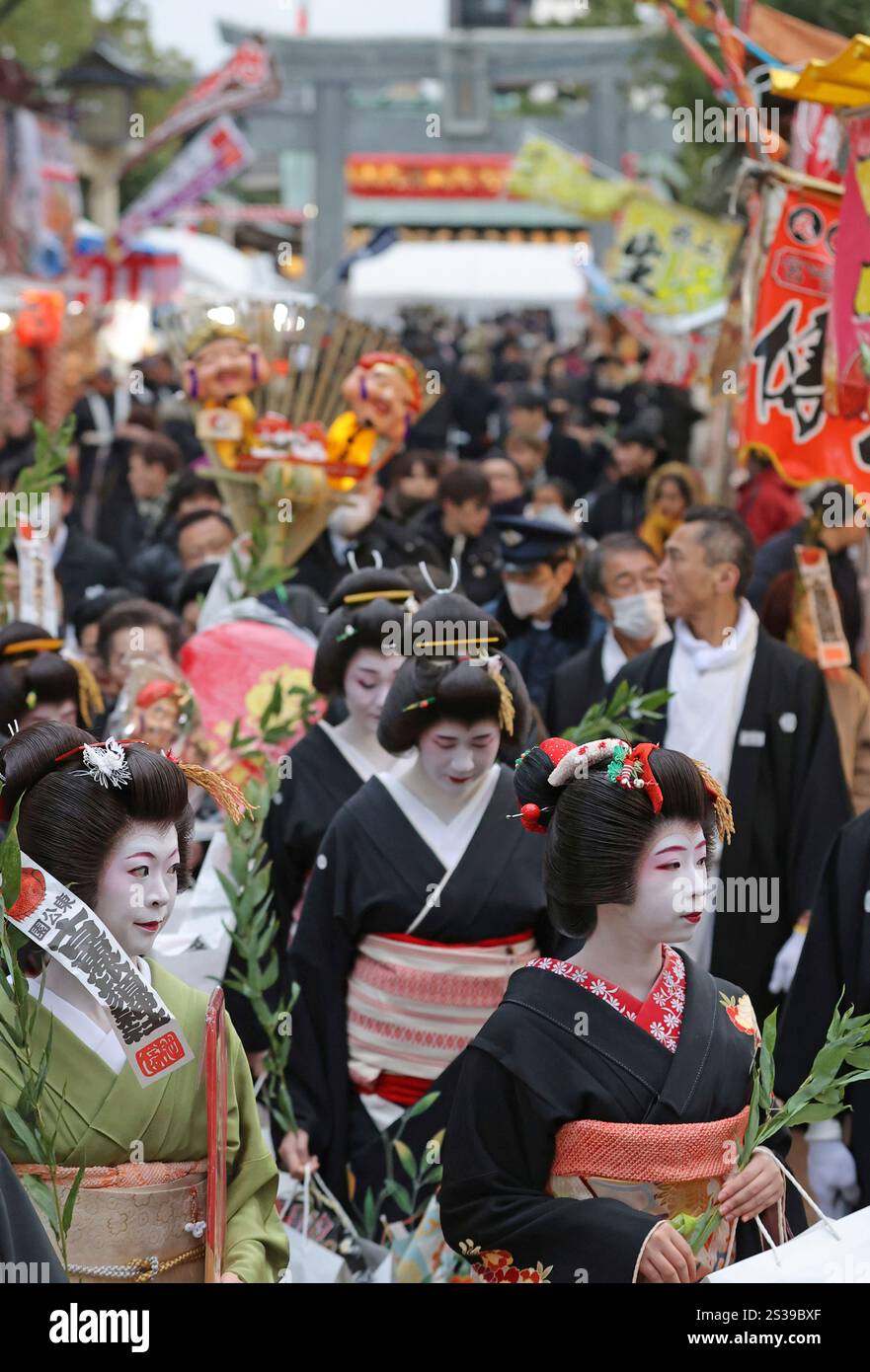 Some Geisha girls parade along the approach to the shrine at Toka Ebisu Shrine in Hakata Ward ...