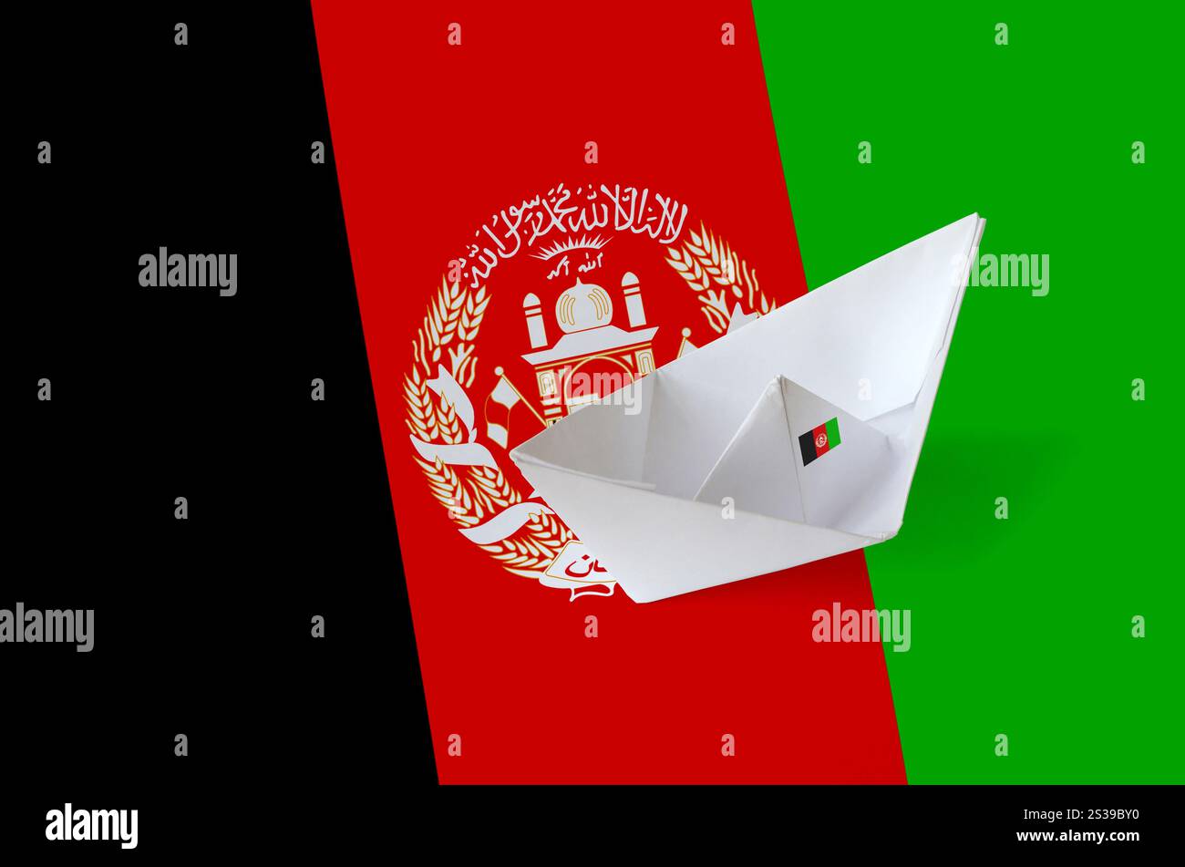 Afghanistan flag depicted on paper origami ship closeup. Oriental ...
