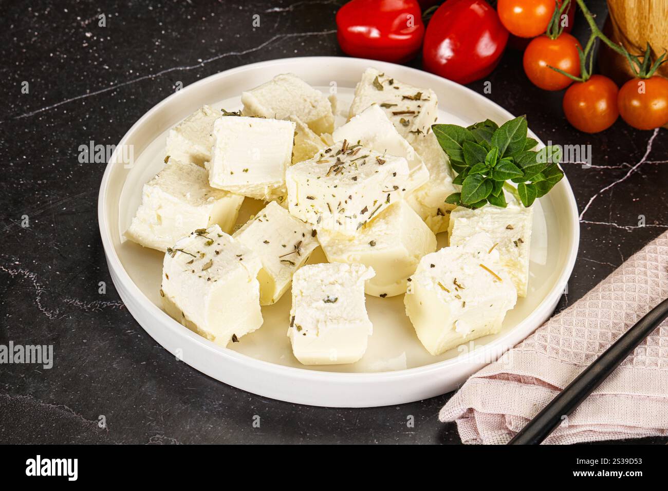 Greek traditional Feta cheese cubes with herbs and spices Stock Photo ...