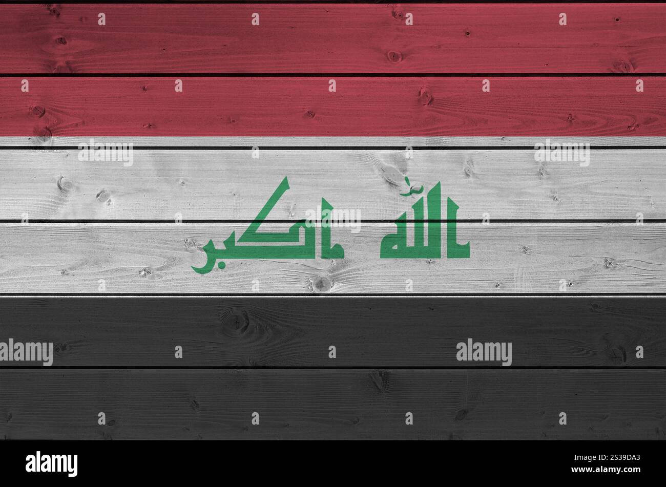 Iraq flag depicted in bright paint colors on old wooden wall close up ...