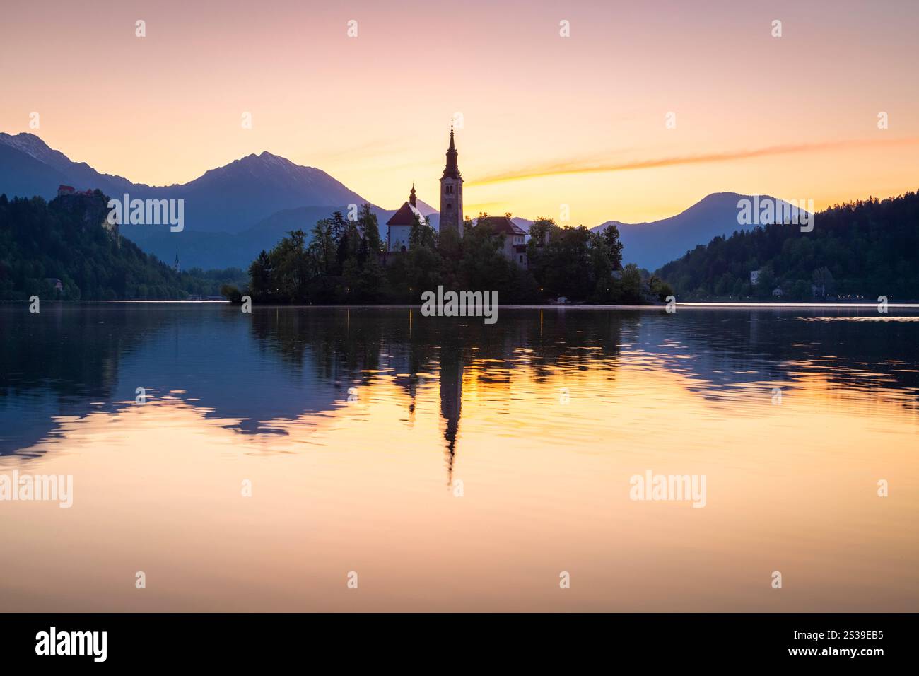 View of lake Bled at in spring with the small island and Assumption of ...