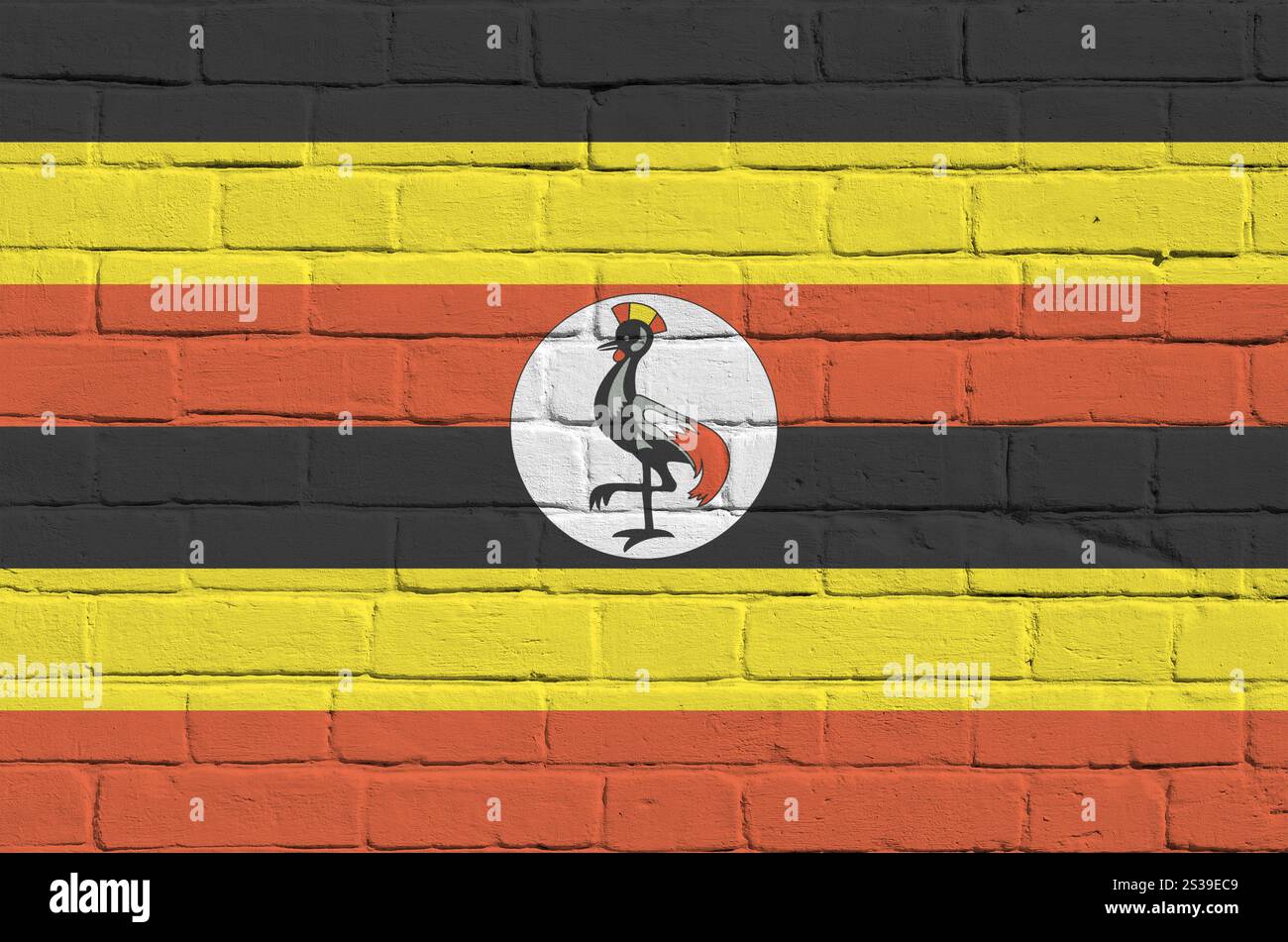 Uganda flag depicted in paint colors on old brick wall close up ...