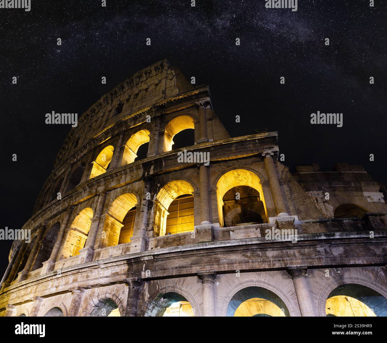 Colosseum ruins night view with Milky Way stars sky. The symbol of ...