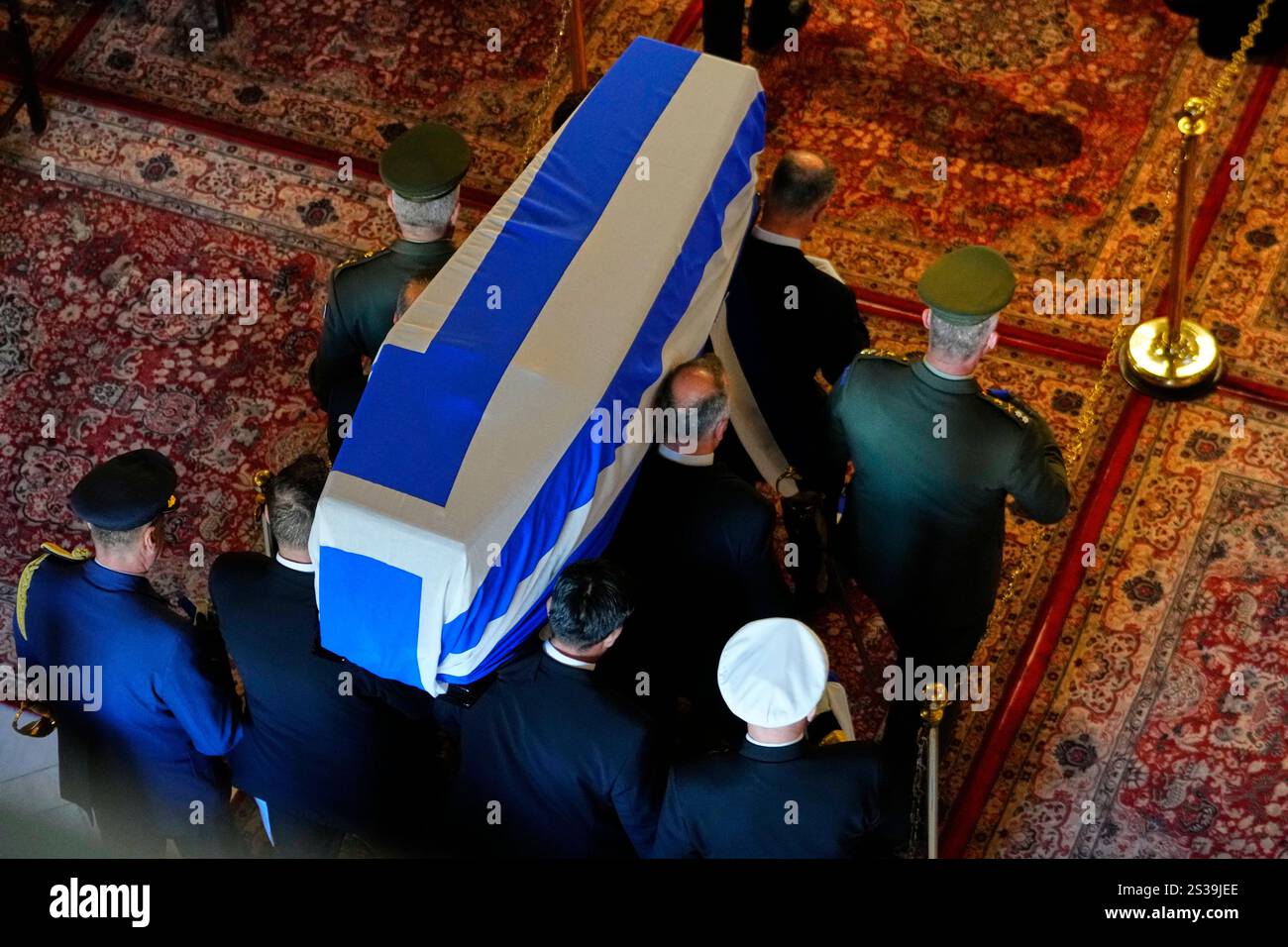 Military officers accompanied the Greek flag-draped casket during the ...