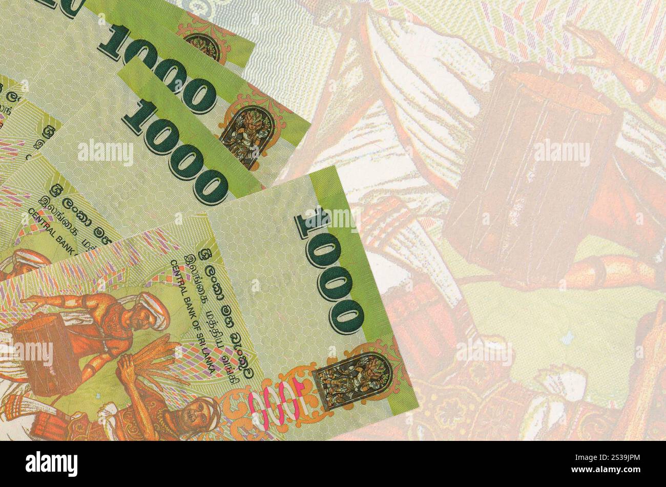 1000 Sri Lankan rupees bills lies in stack on background of big semi ...