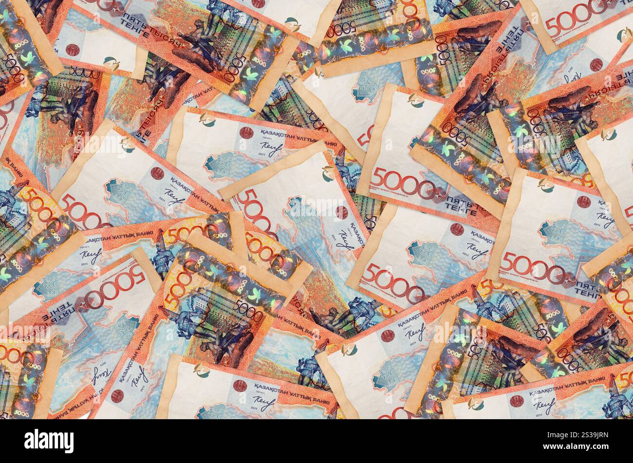 5000 Kazakhstani tenge bills lies in big pile. Rich life conceptual ...