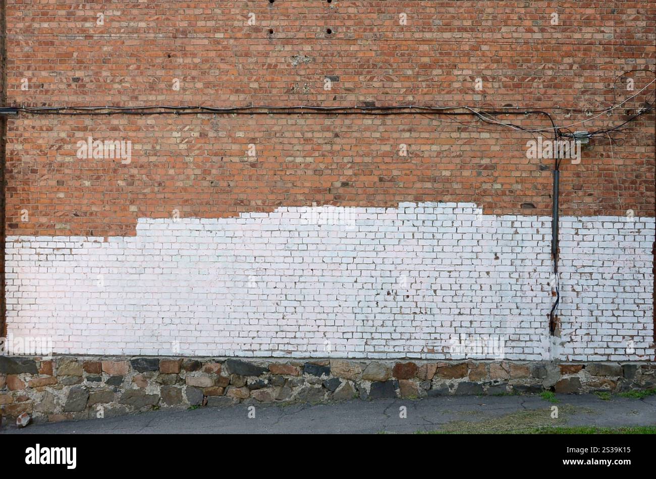 Residental house wall with white paint patches covering graffiti ...